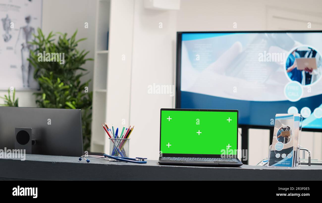 Laptop with greenscreen display at desk Stock Photo - Alamy