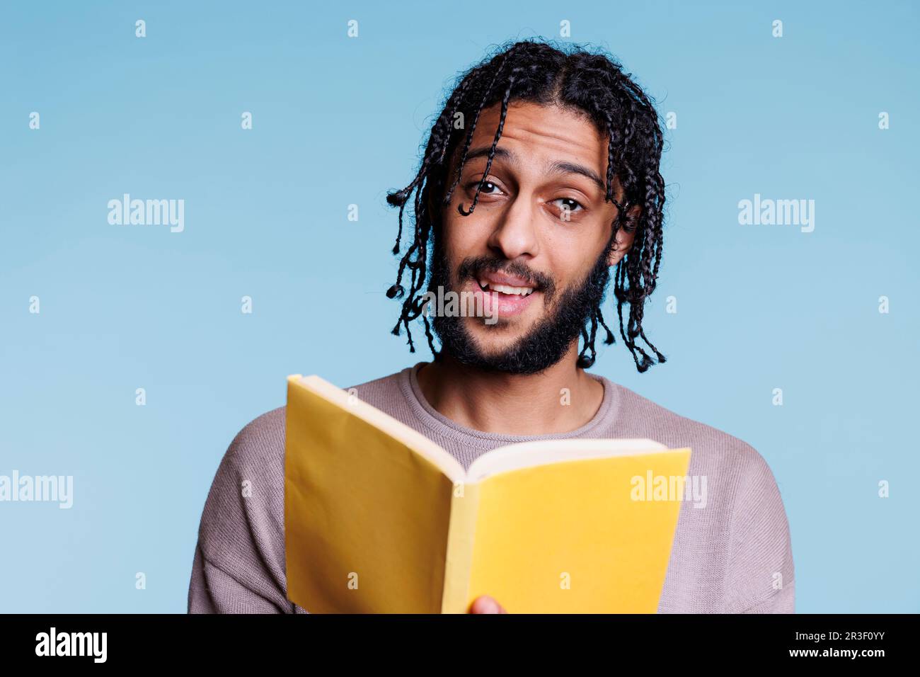 Man holding book and talking about novel plot portrait Stock Photo - Alamy