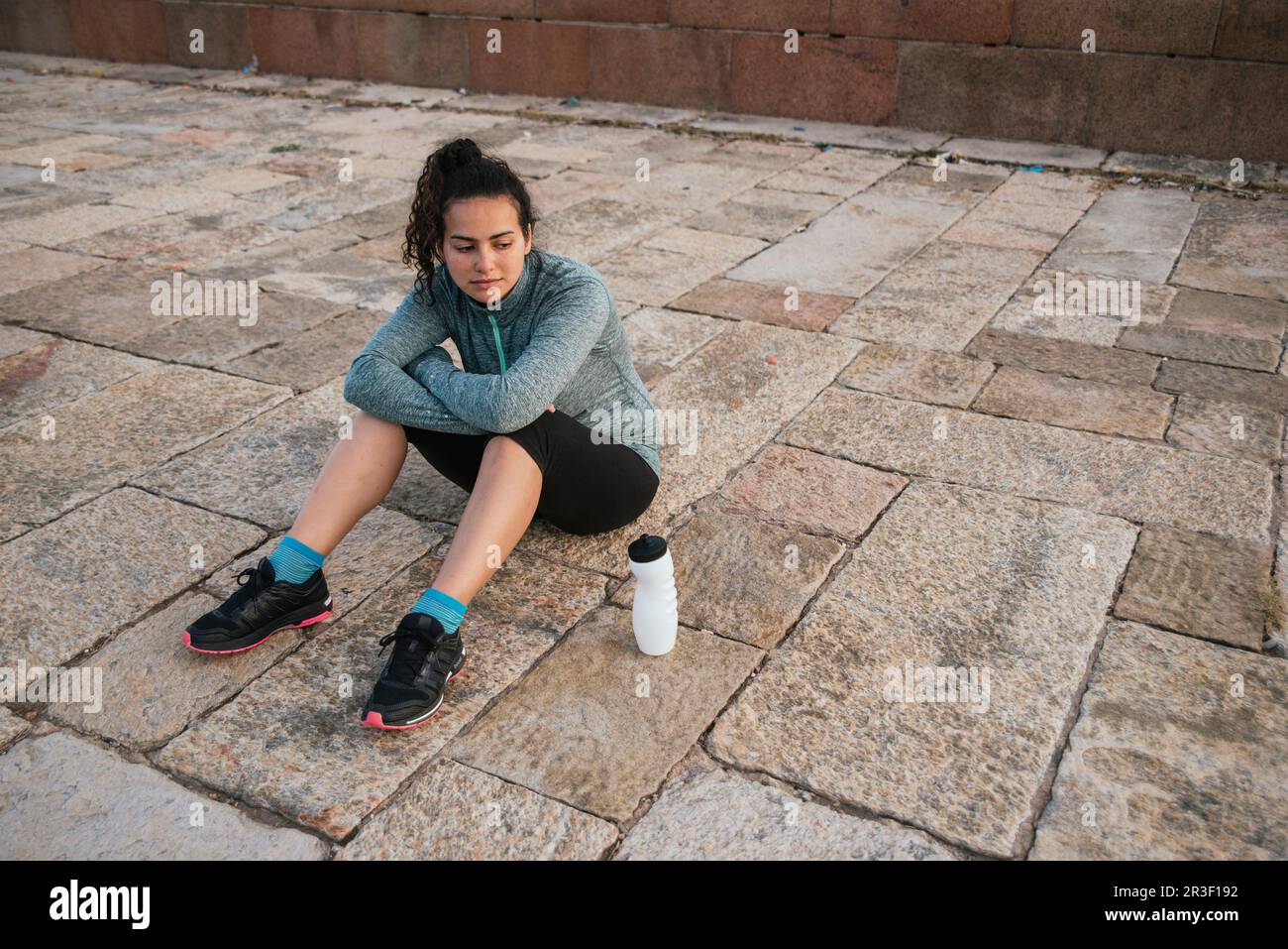 young woman sitting after run Stock Photo - Alamy