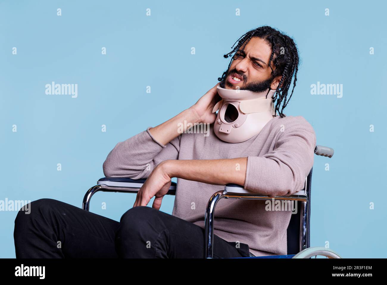 Arab man with painful facial expression having neck injury Stock Photo ...