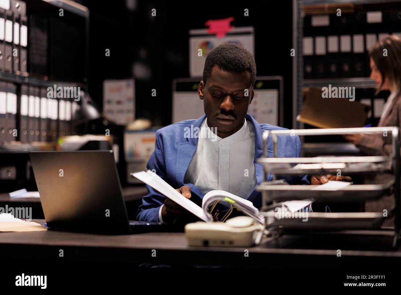 Detective reading criminology files Stock Photo - Alamy