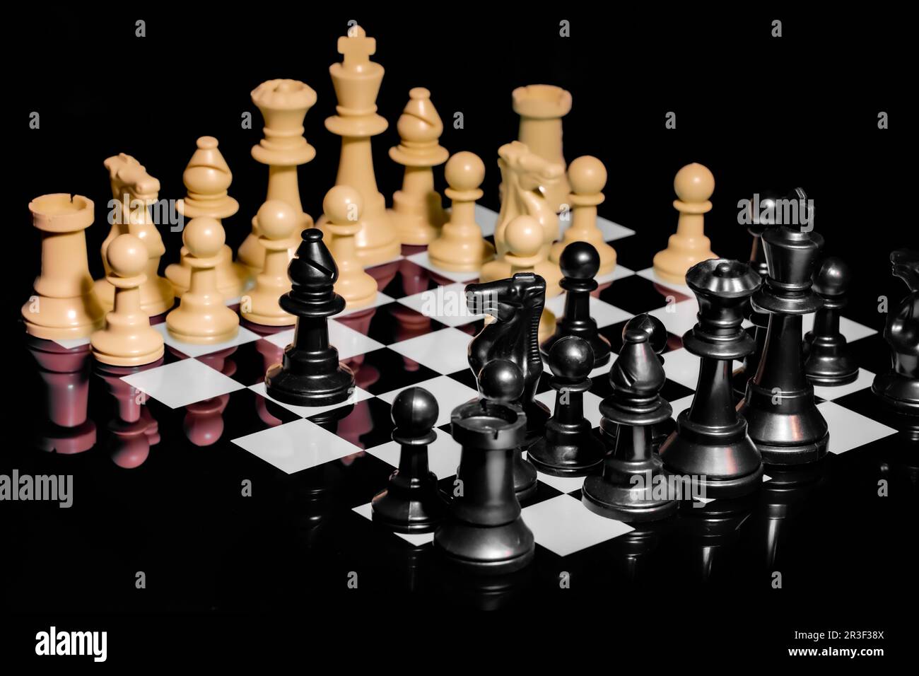 Close up of Chess pieces on a reflective mirror board surface with ...