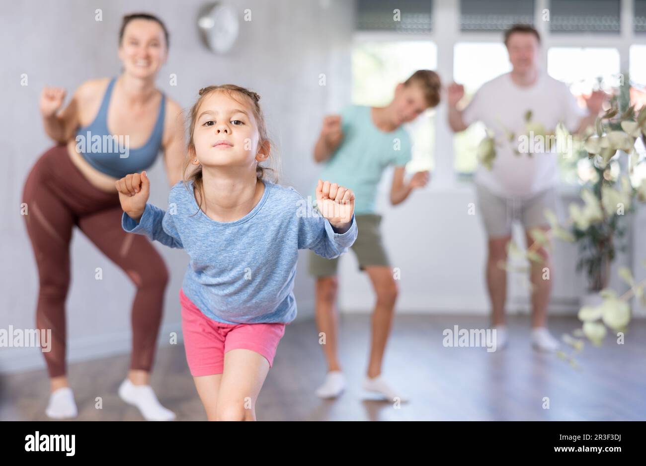 Positive pre teenage dancers and his parent doing dance workout during ...