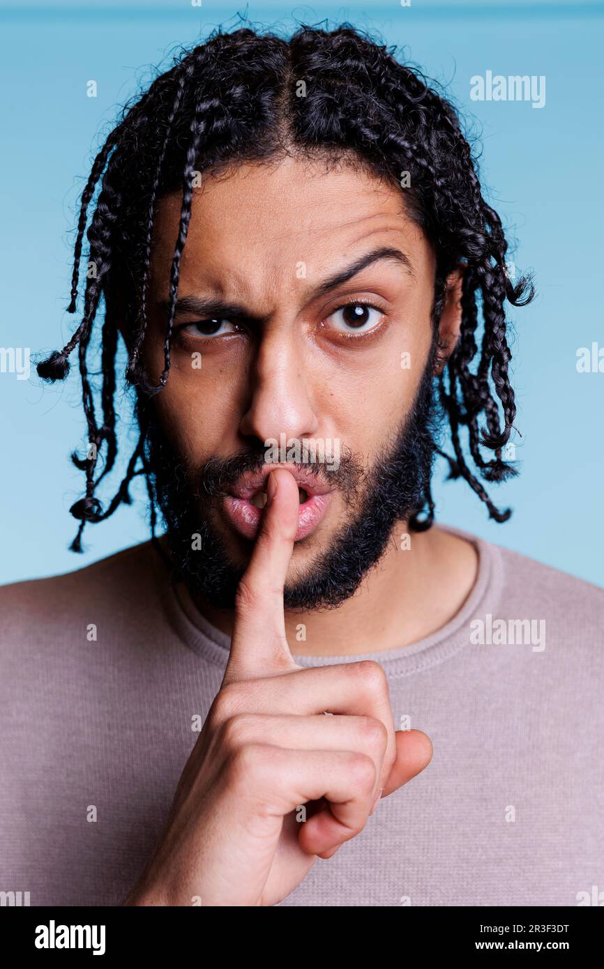 Irritated arab man making shh sign with serious expression Stock Photo ...