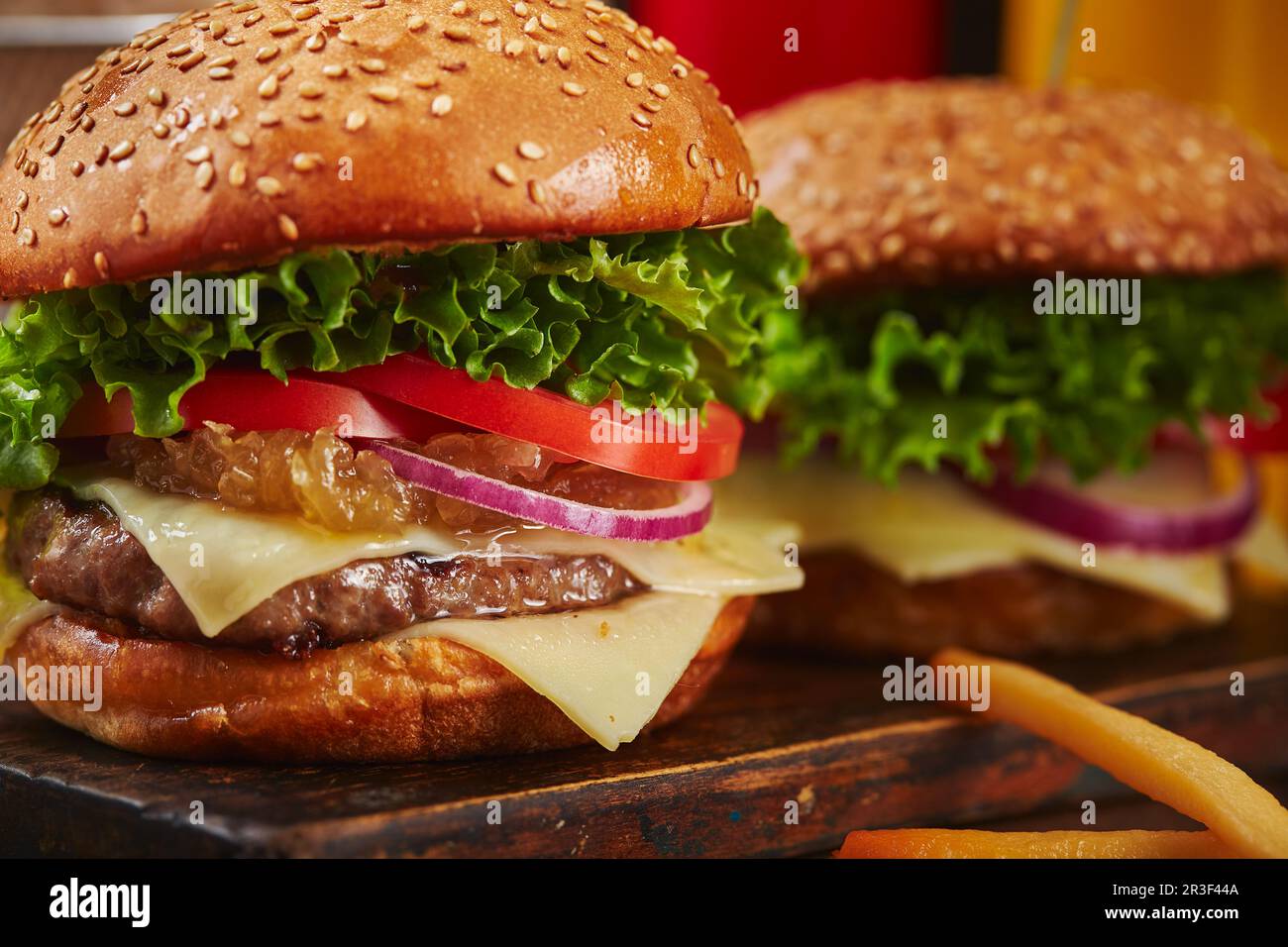 Appetizing homemade burger with beef, cheese and onion marmalade close ...