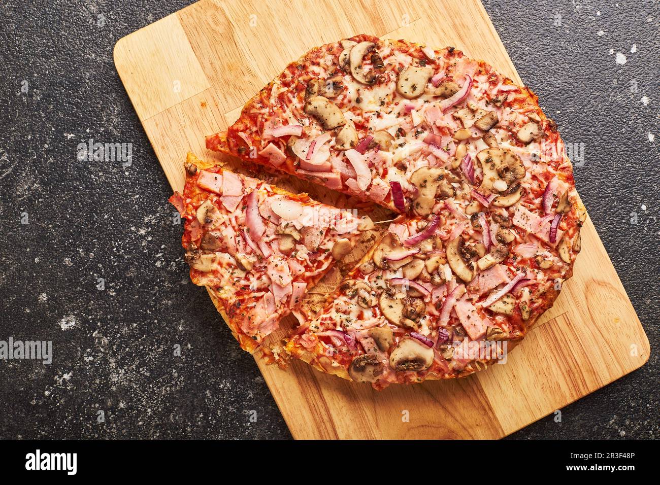 Fast food, Baked frozen pizza with ham, mushrooms and cheese on thick ...