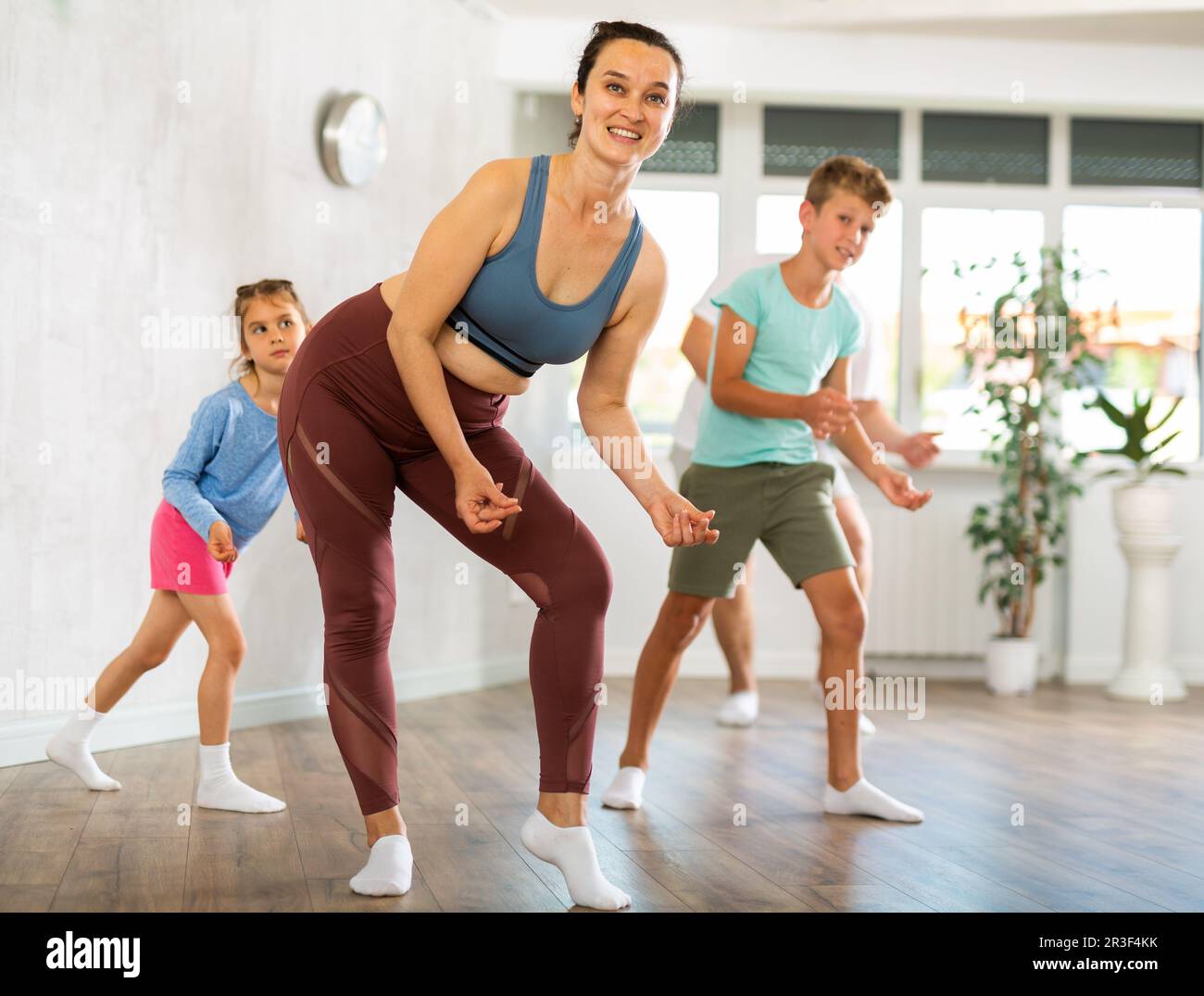 Family with two children dancing in studio Stock Photo - Alamy
