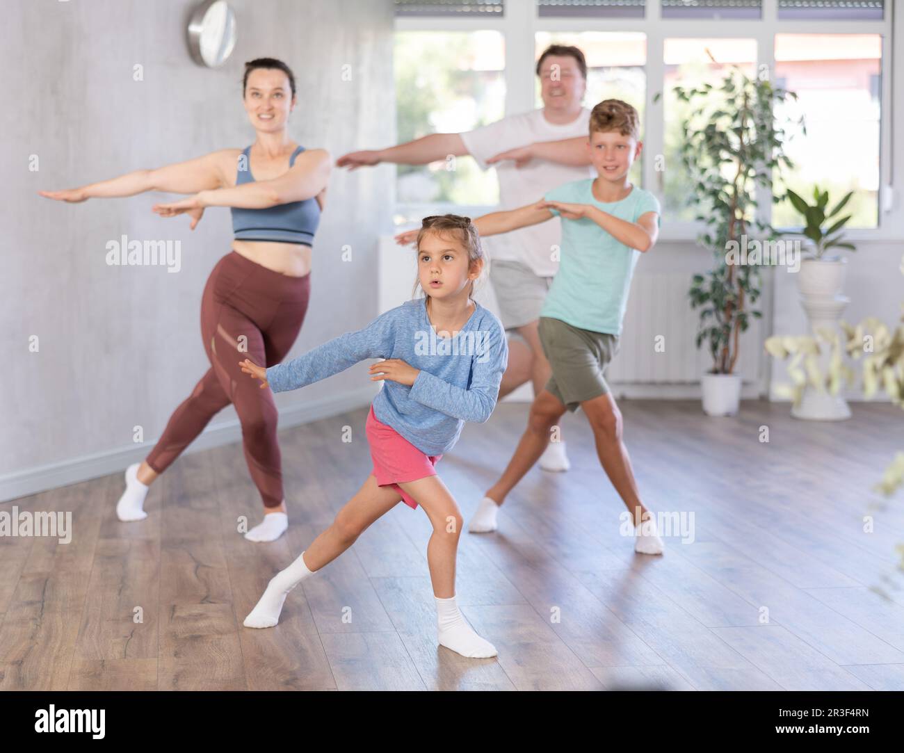 Family with two children dancing in studio Stock Photo - Alamy
