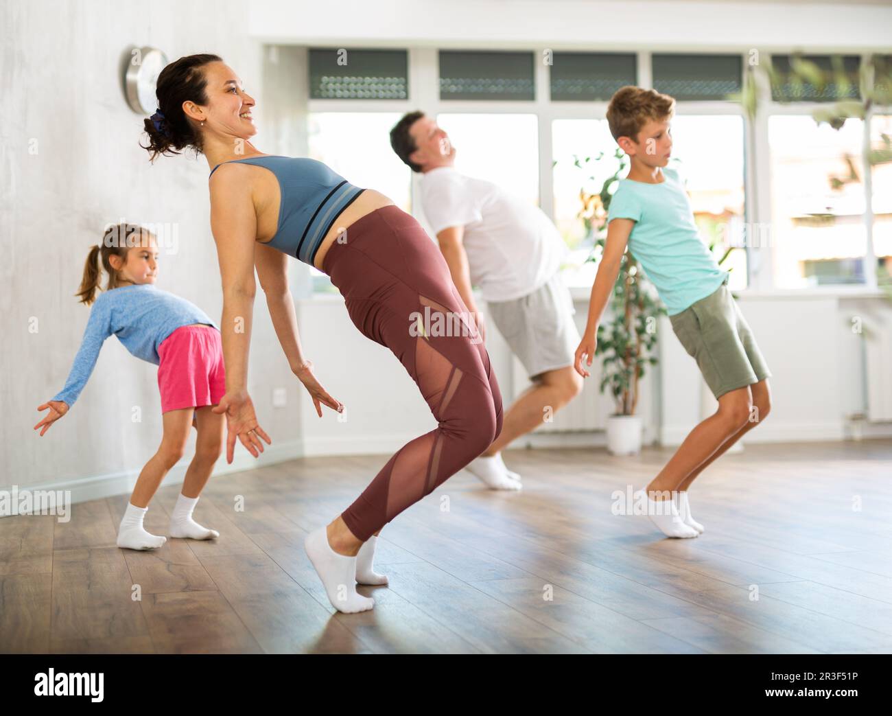 Family with two children dancing in studio Stock Photo - Alamy