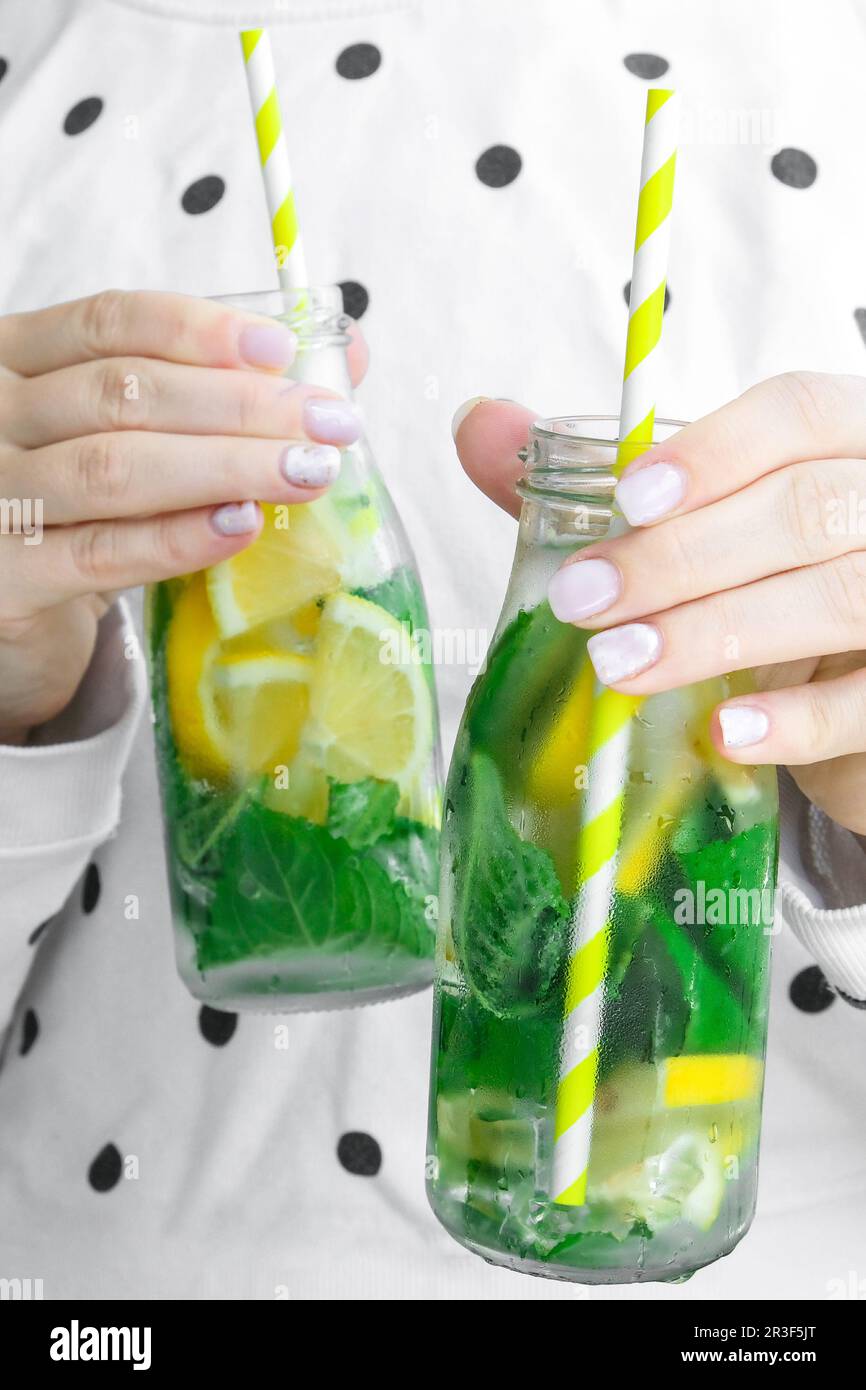 Female hand holding Mojito refreshing cocktail with eco paper drinking ...