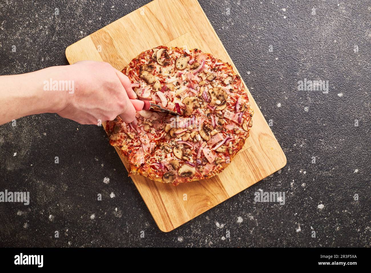 Fast food, Baked frozen pizza with ham, mushrooms and cheese on thick ...