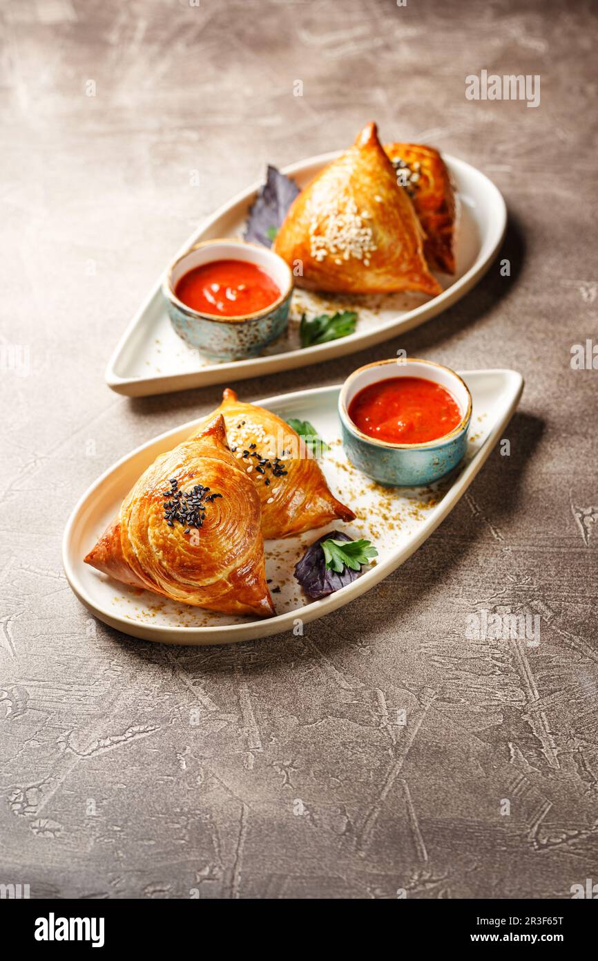 Samosa, samsa meat stuffed pies. Uzbek national dish samosa. Concept of Central Asian, South and ...