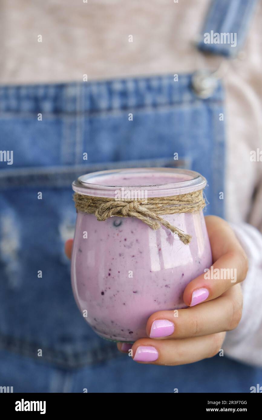 Female hands holding Blueberry smoothie topped with blueberries. Woman ...