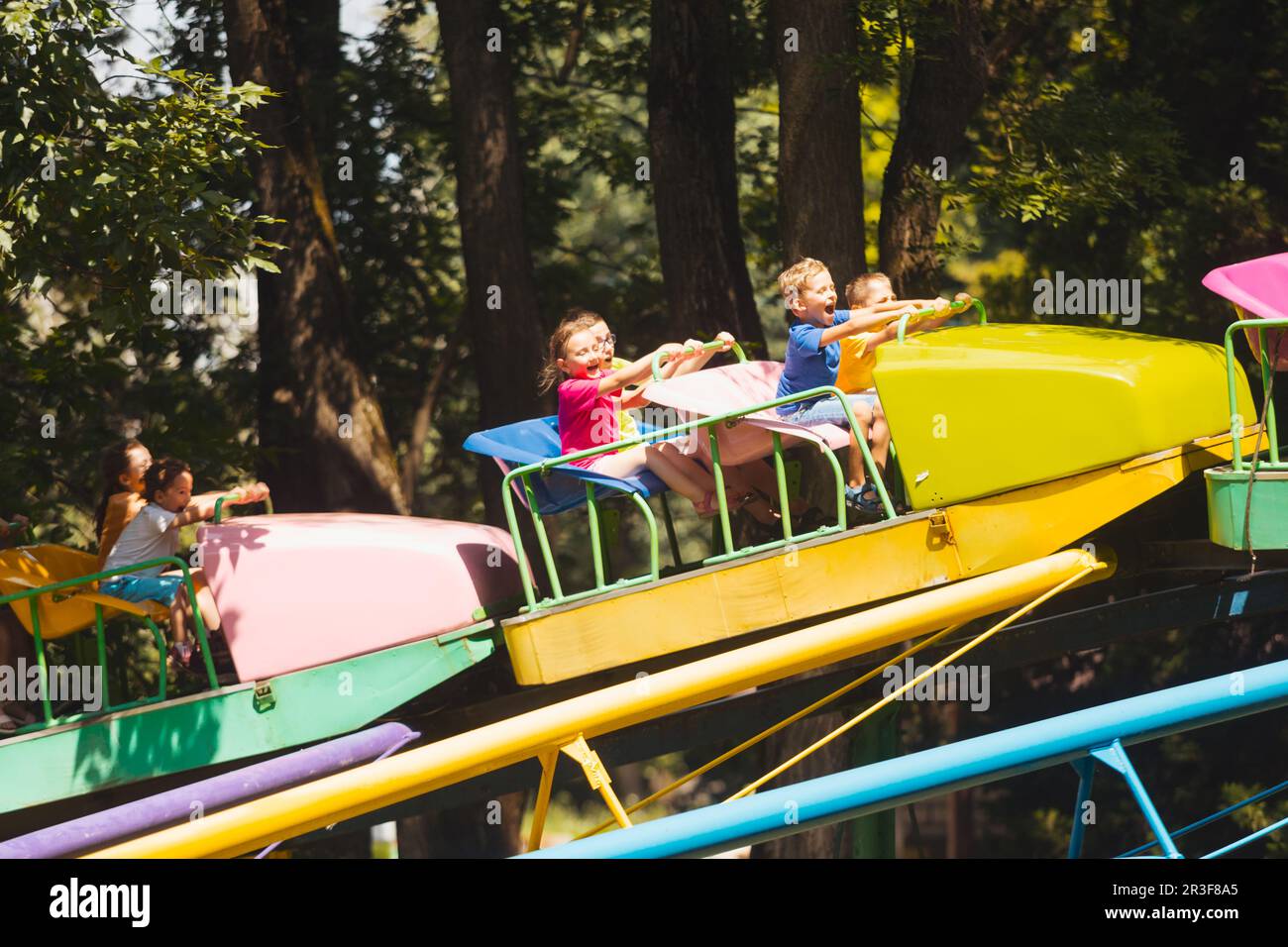 Kids on colorful amusement park hi-res stock photography and images - Alamy