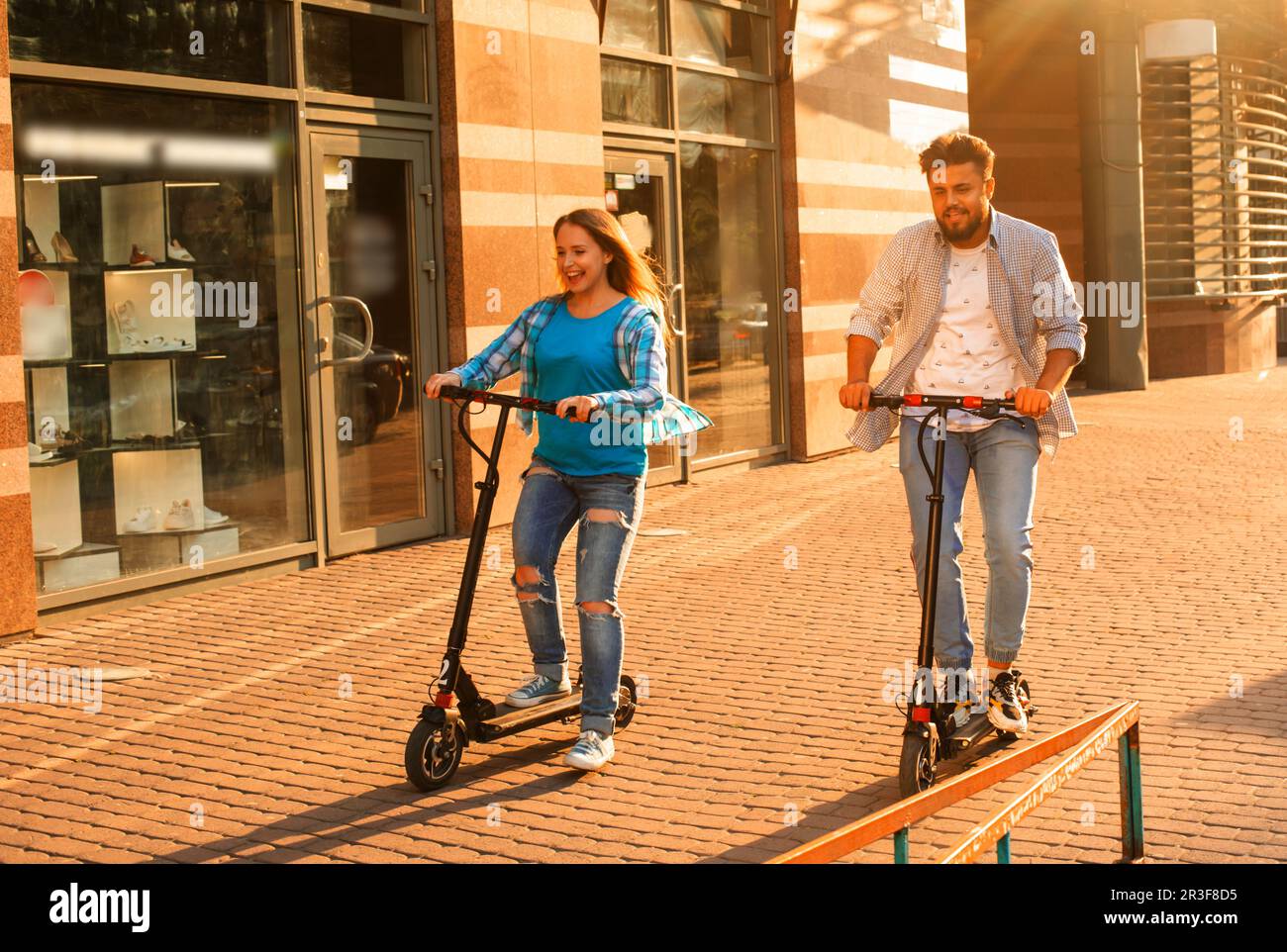The young couple spend time together riding electric scooter in the ...