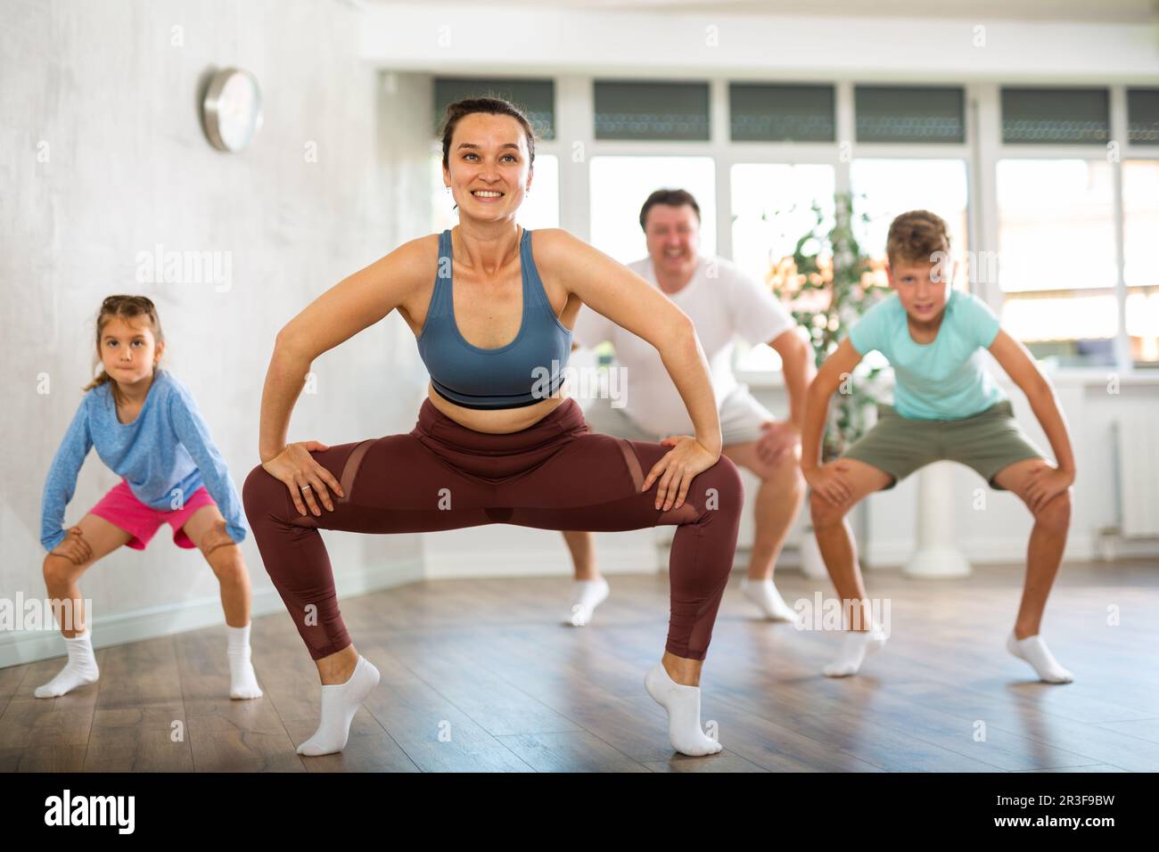 Parents together with their children learn how to dance salsa or boogie ...