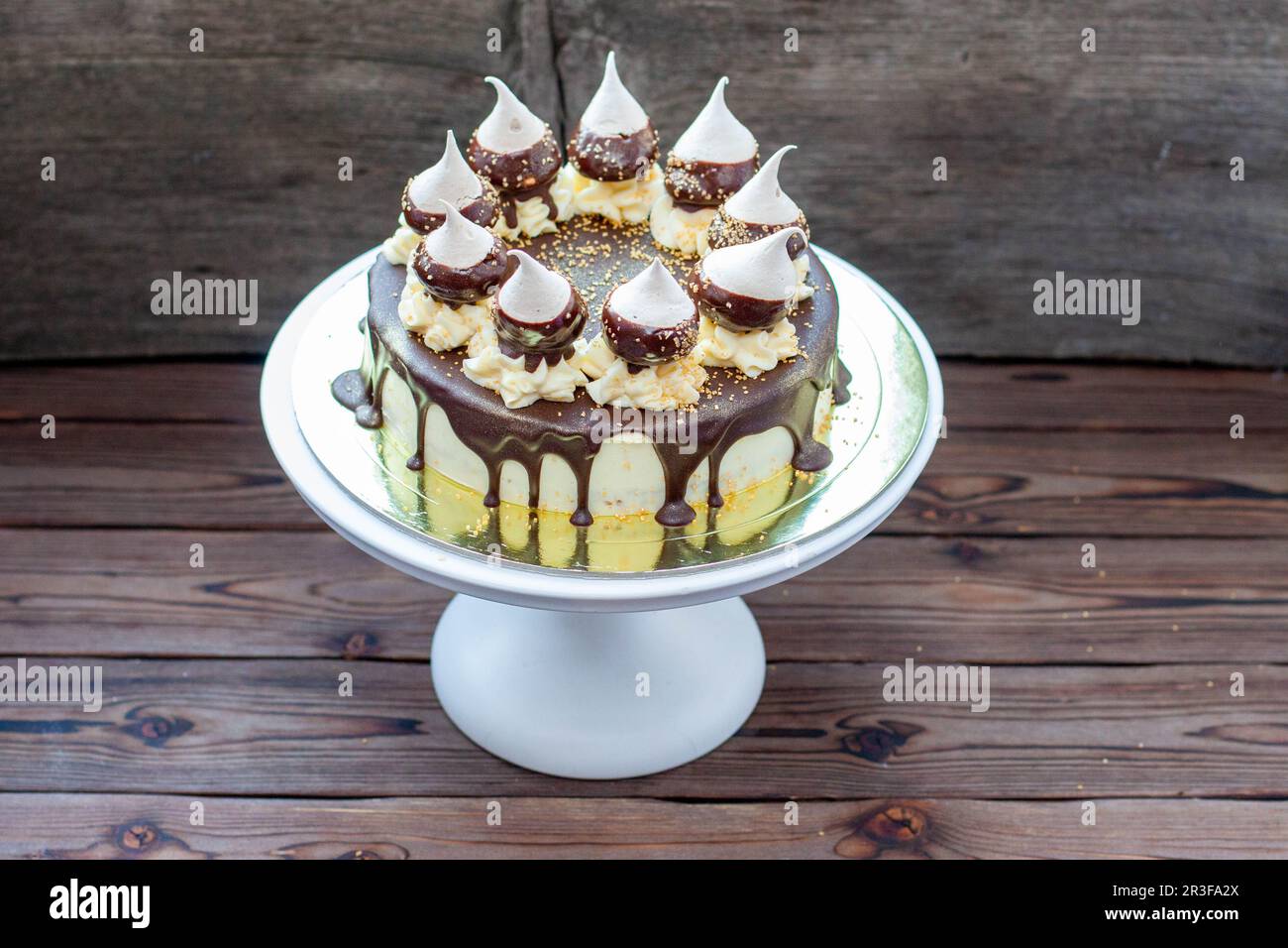 Birthday cheesecake decorated with melted dark chocolate sauce ...