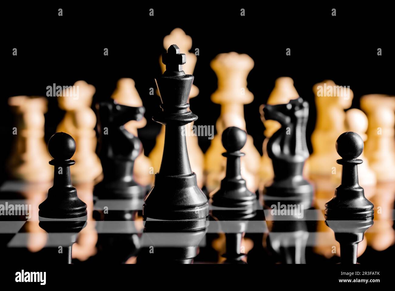 Close up of Chess pieces on a reflective mirror board surface with ...