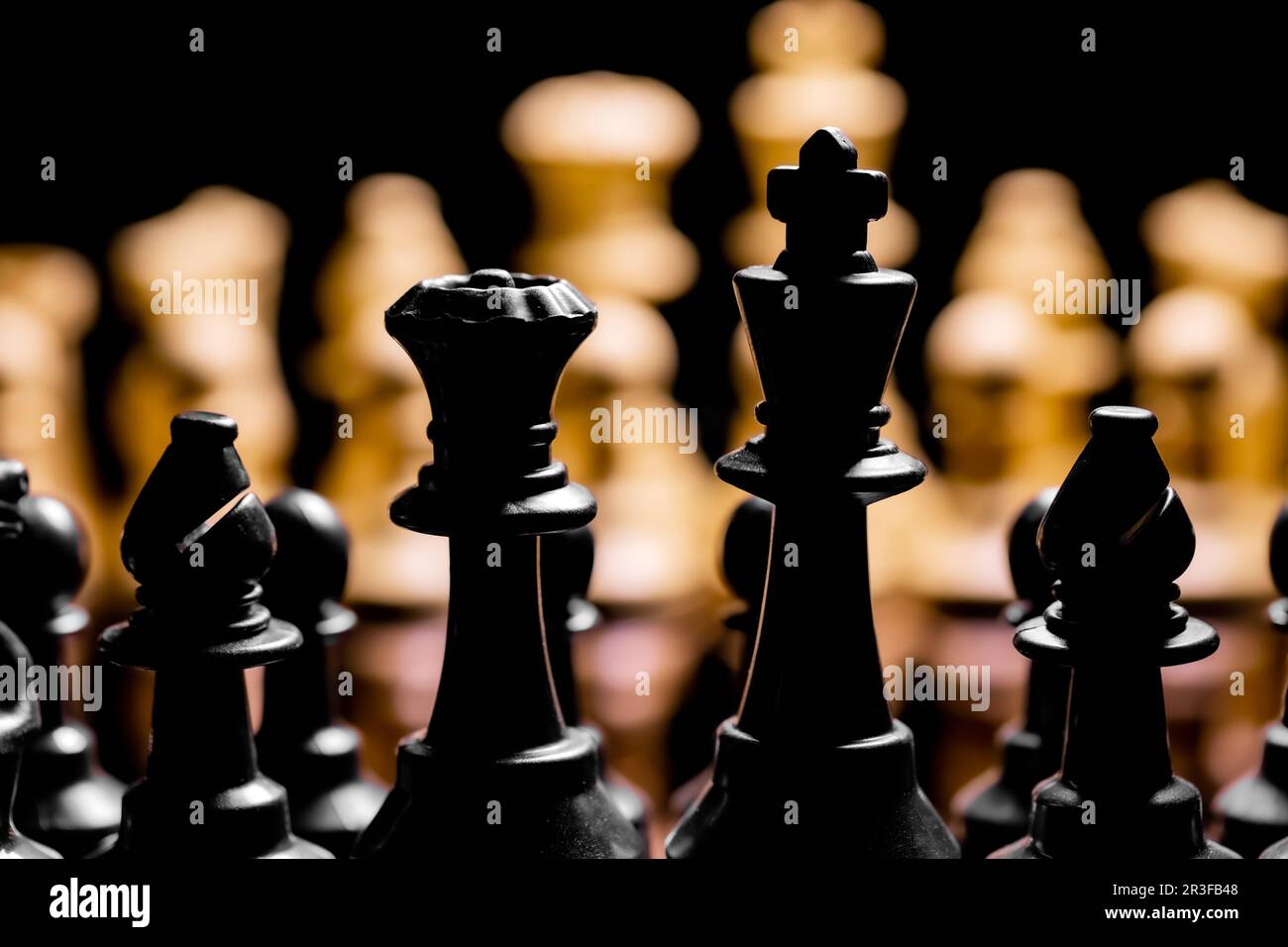 Close up of Chess pieces on a reflective mirror board surface with ...