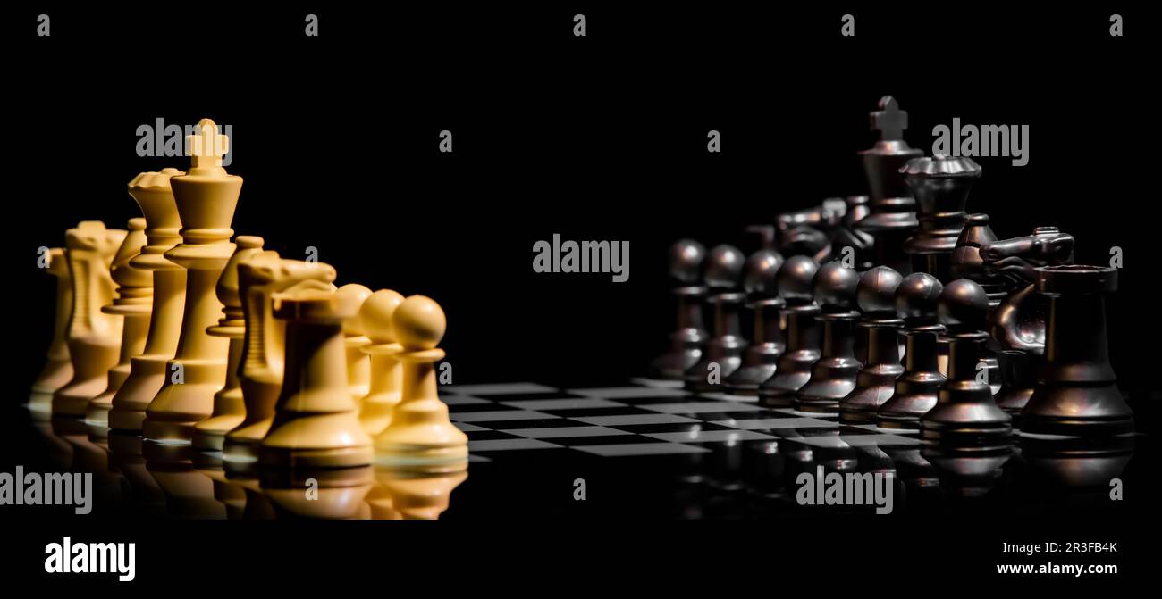 Close up of Chess pieces on a reflective mirror board surface with ...