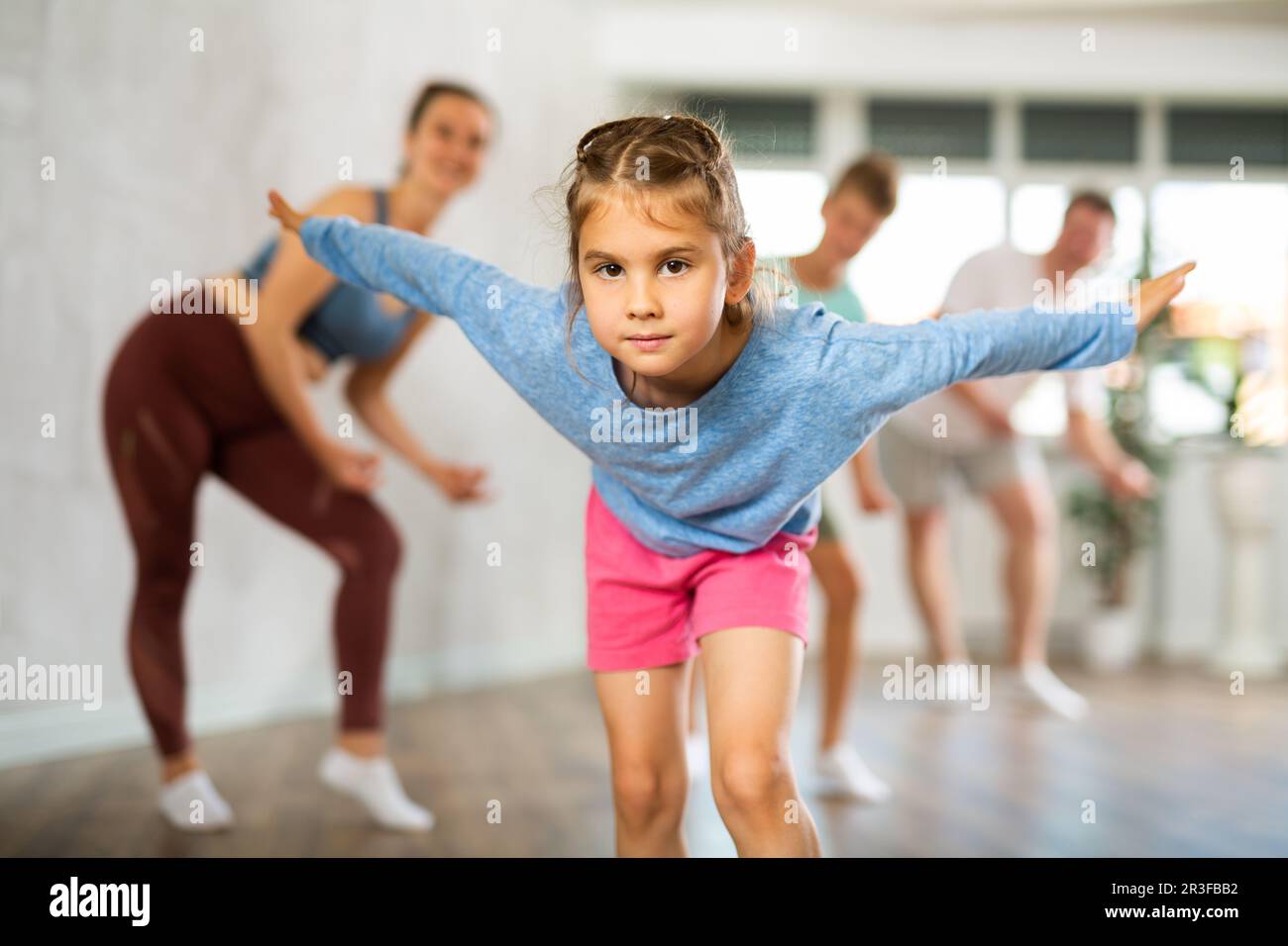 Family with two children dancing in studio Stock Photo - Alamy