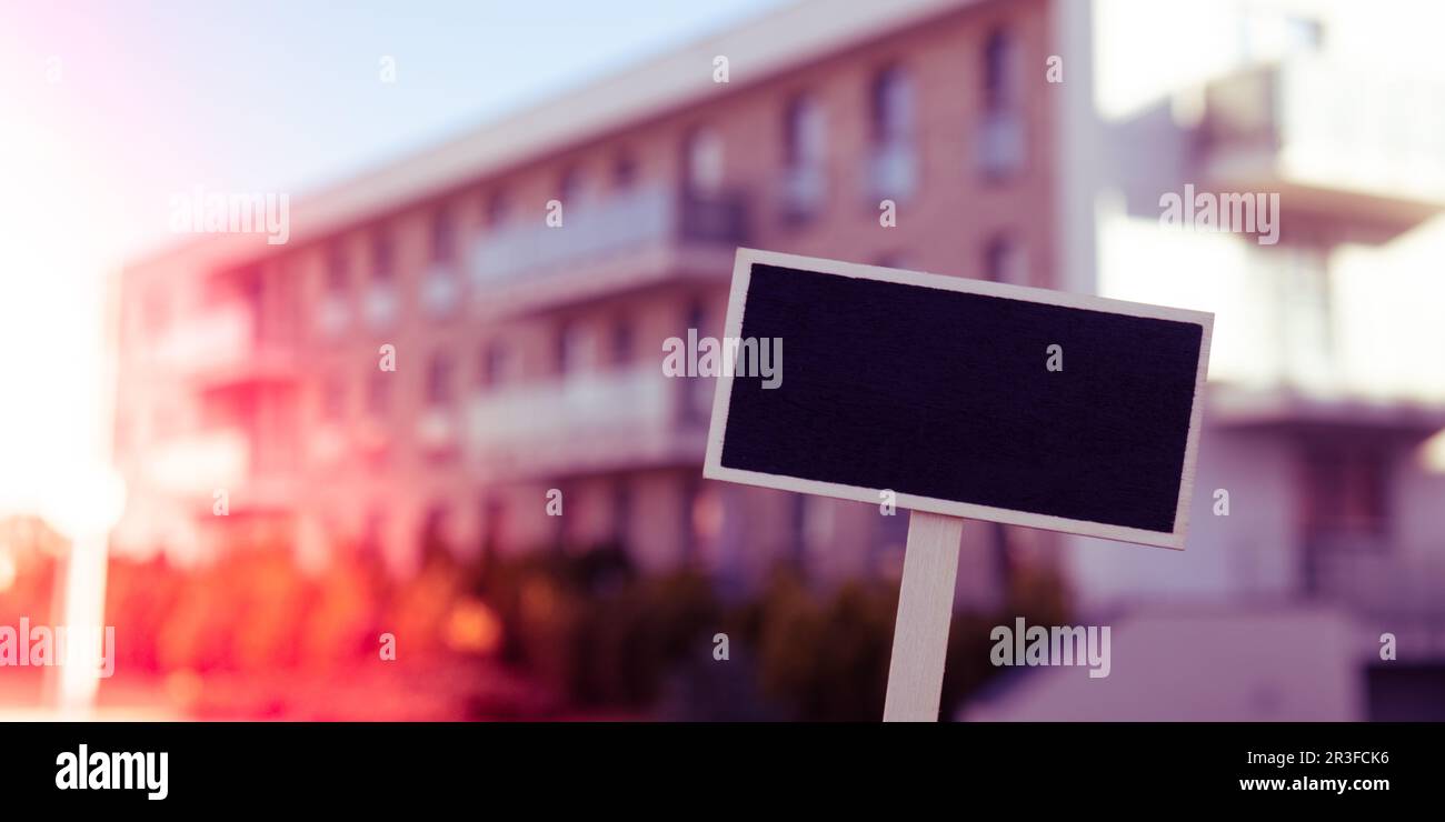 Blank Black billboard against new apartment building Empty mockup ...