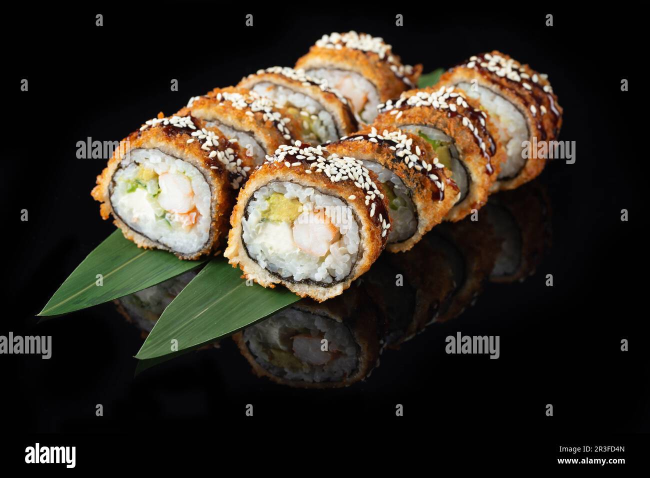 Traditional delicious fresh sushi roll set on a black background with ...