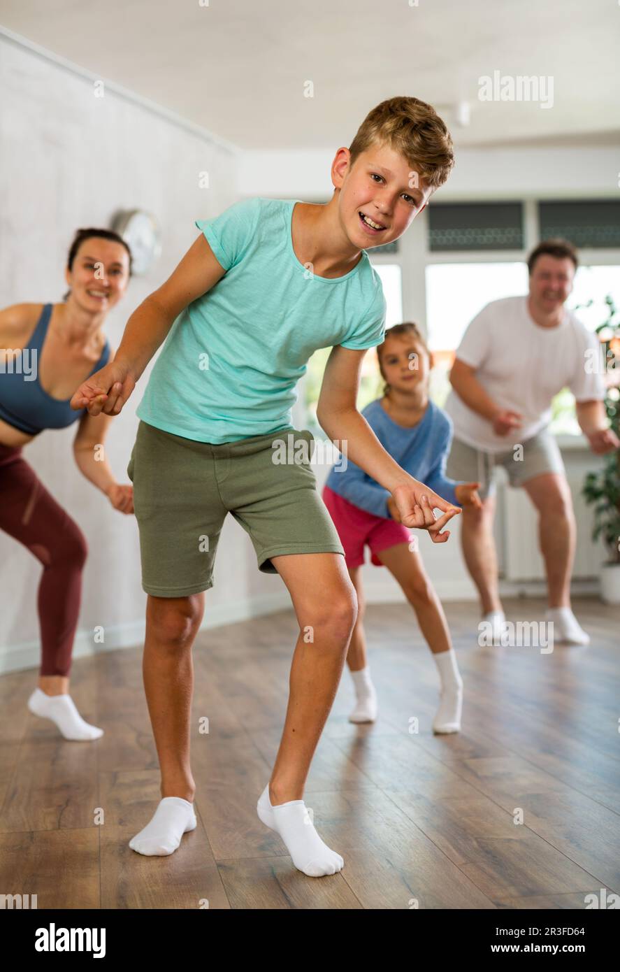 At home child learns to perform boogie-woogie figures with family Stock ...