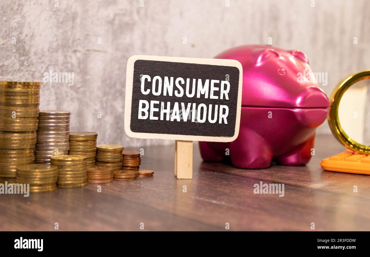 mini black board with text consumer behaviour isolated on wooden ...