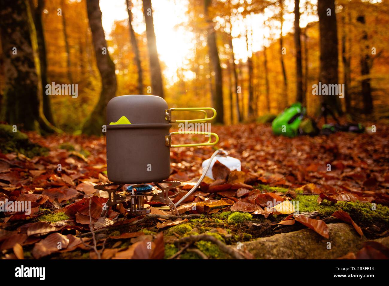 Cooking hot dish to warp up while autumn hiking Stock Photo - Alamy