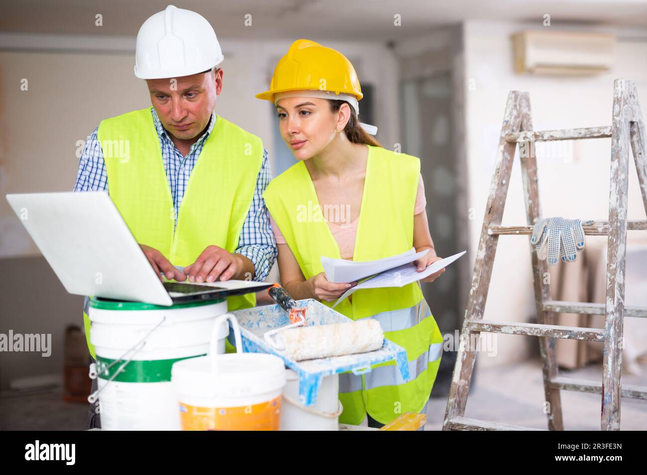 Construction workers working at house being renovated Stock Photo - Alamy