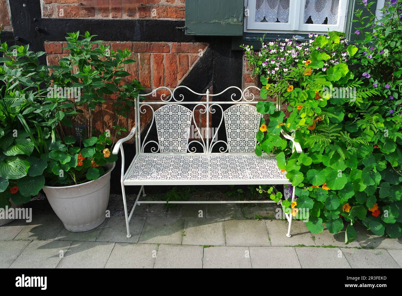 Garden bench in front of the house Stock Photo - Alamy