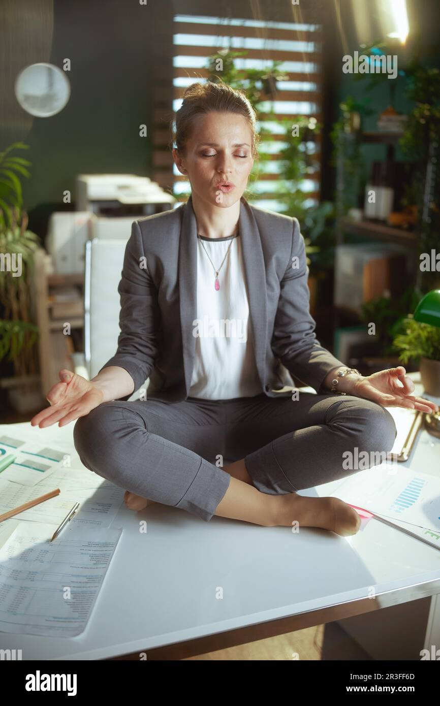 Sustainable workplace. relaxed modern business woman in modern green ...