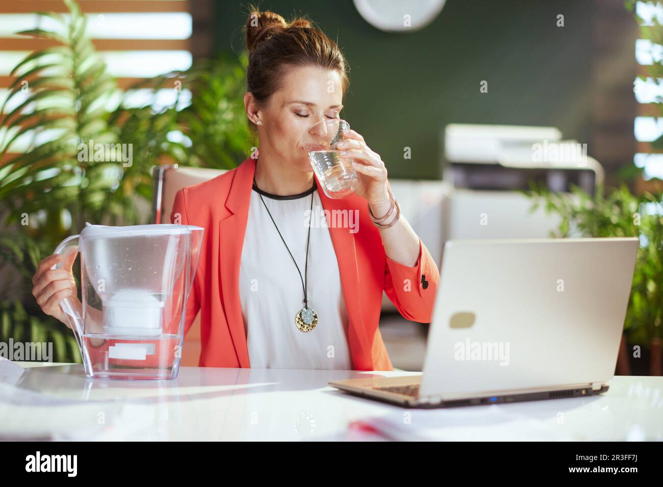 Sustainable workplace. modern business woman in modern green office in ...