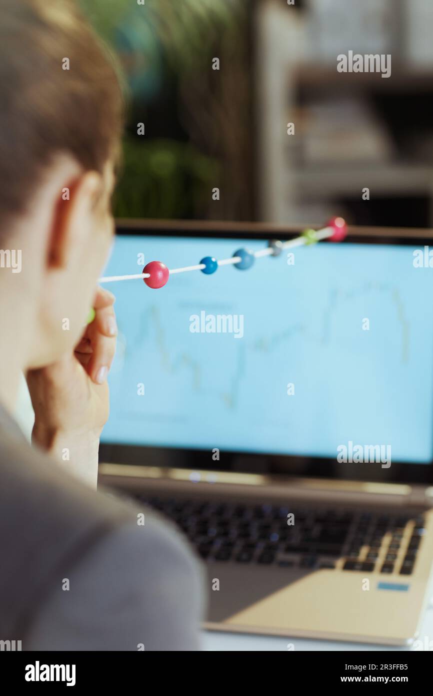 Sustainable workplace. Seen from behind modern business woman in a grey ...