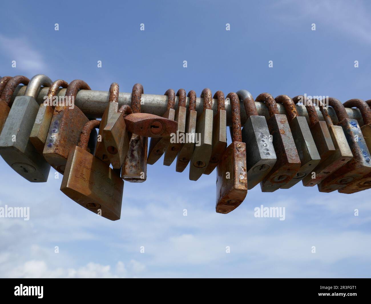 Rusty love locks on sky background Stock Photo - Alamy