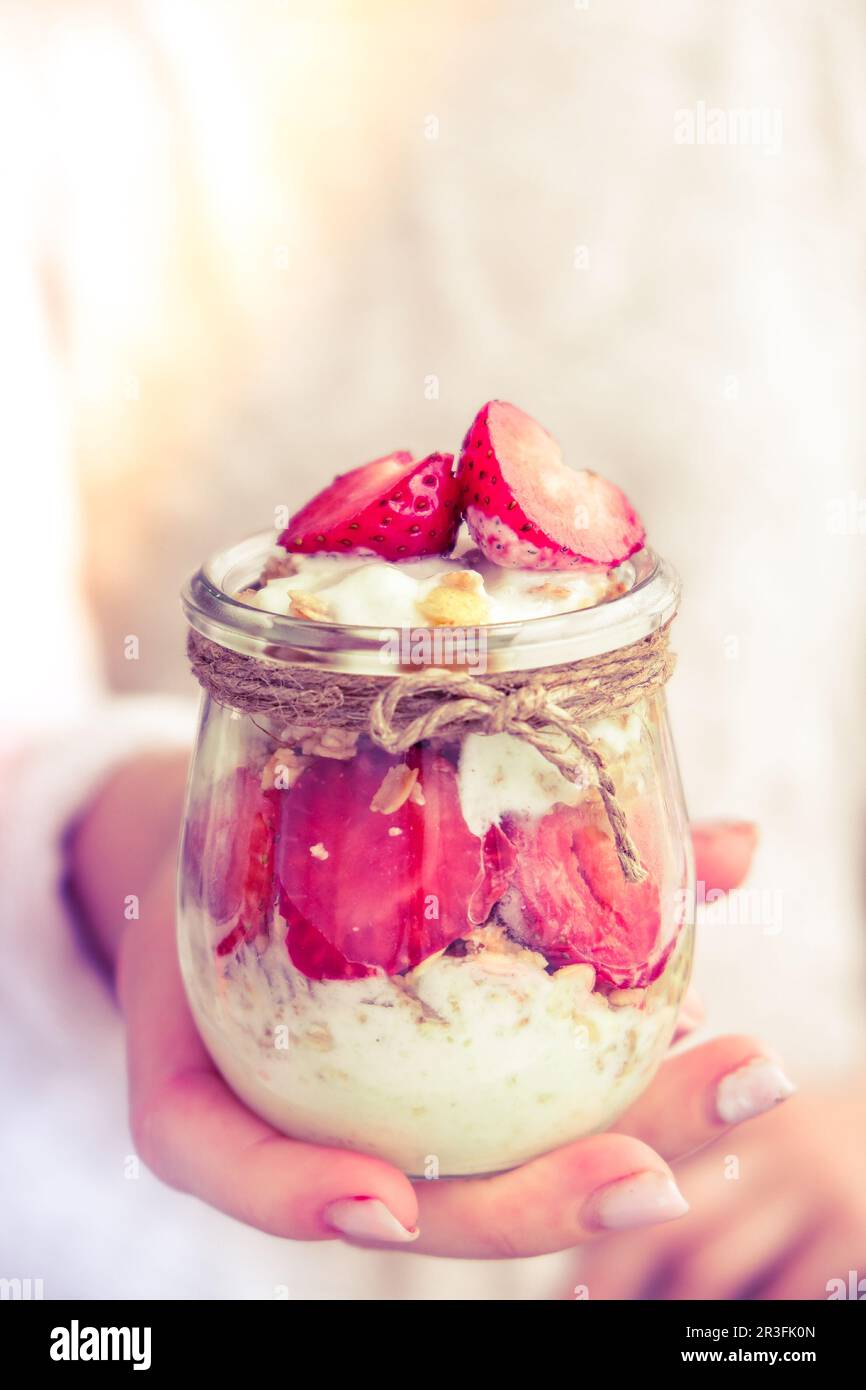 Female hands woman eating Healthy breakfast. Oatmeal Granola with greek ...