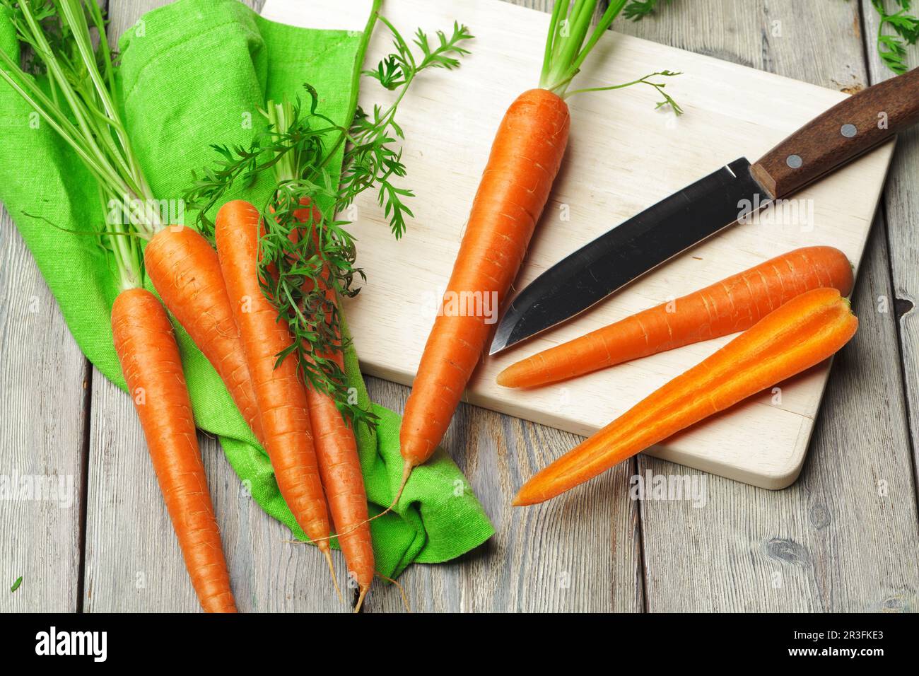 chopping healthy carrots on slice on chopping board in the kitchen ...