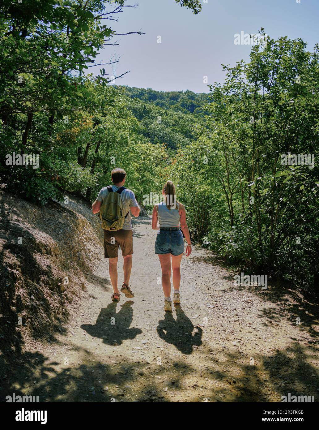 Young man and woman hiking towards the fairytale Burg Eltz Medieval ...