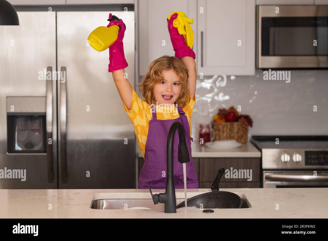 Child doing housework. Cute kid help in washing dishes at kitchen. Kid ...