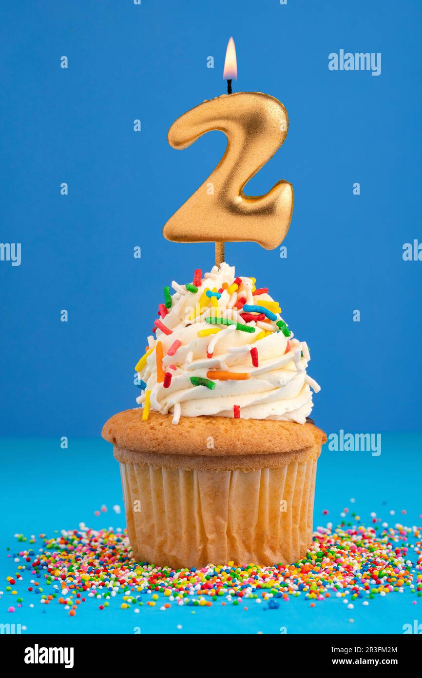 Birthday cake with candle number 2 - Blue background Stock Photo - Alamy