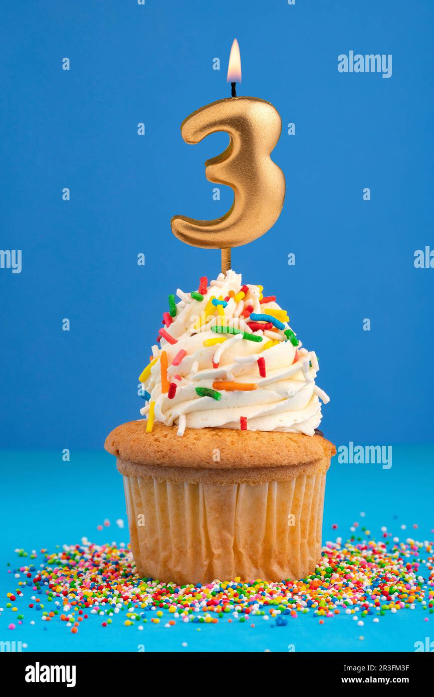 Candle number 3 - Cake birthday in blue background Stock Photo - Alamy