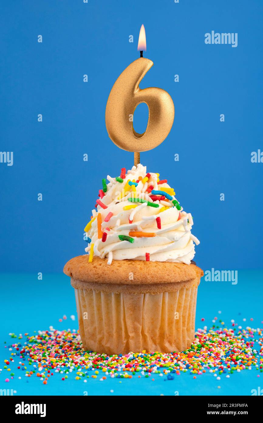 Birthday cake with candle number 6 - Blue background Stock Photo - Alamy
