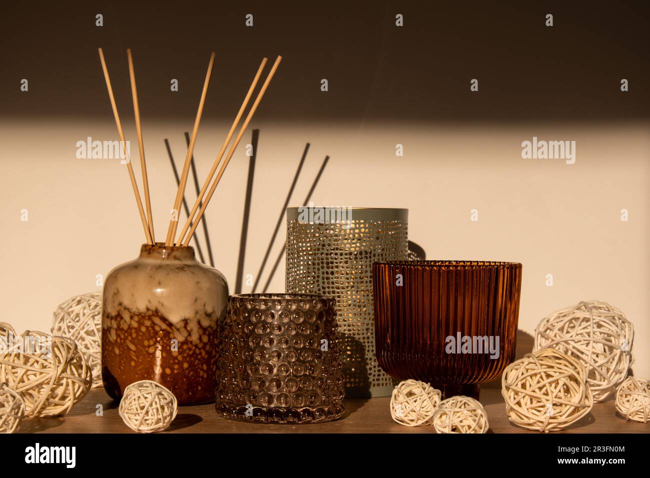 Candle and aromatic reed freshener on table. Aroma liquid in glass ...