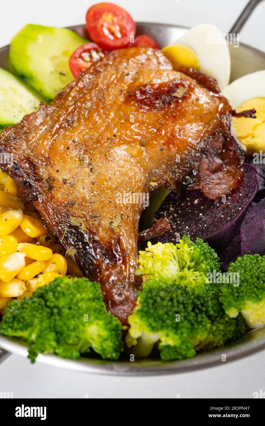 angle view healthy meal with roasted chicken leg and cucumber and eggs ...