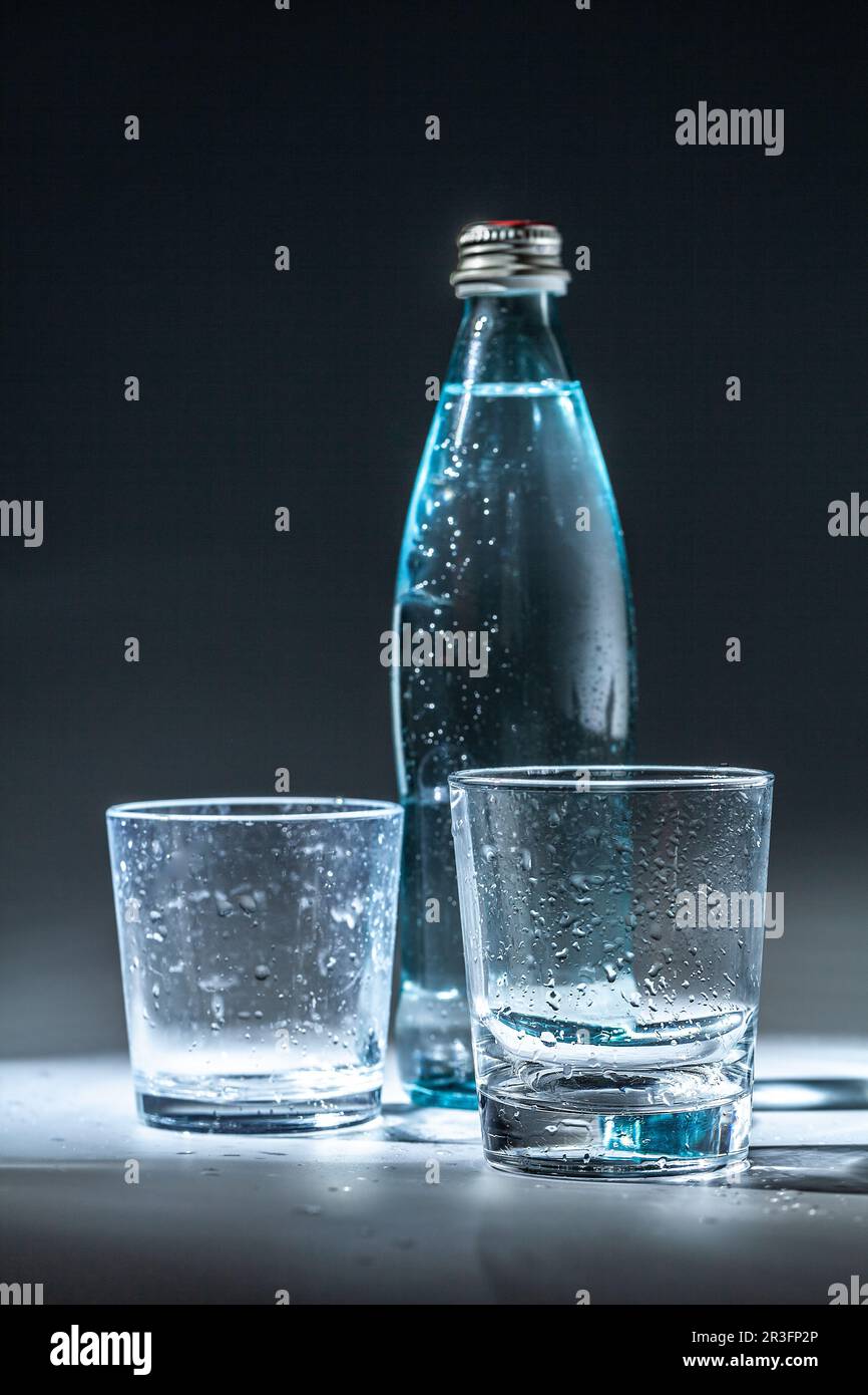 Served table set of mineral water bottle and glass Stock Photo - Alamy