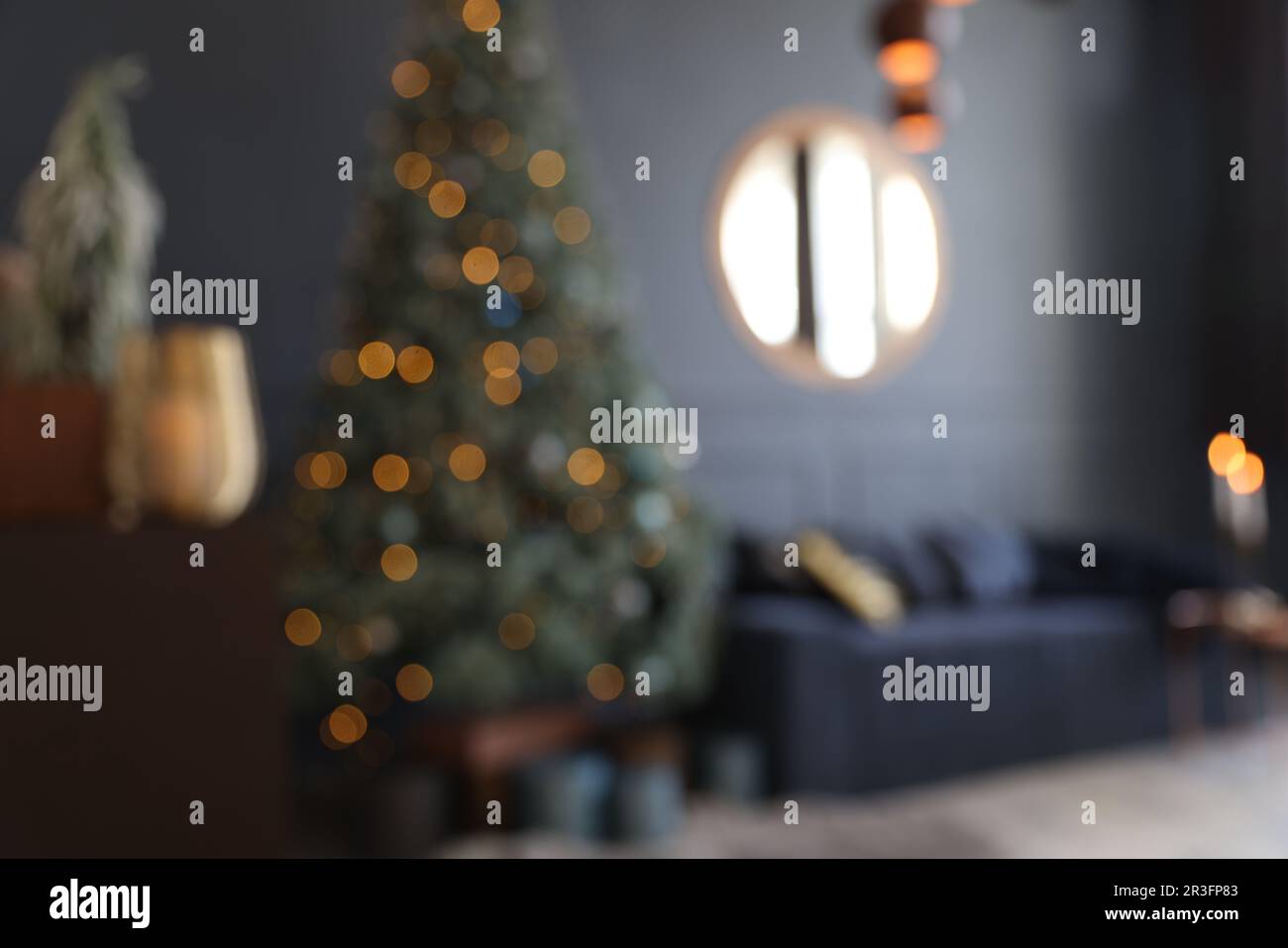 Blurred view of living room interior with Christmas tree and festive ...