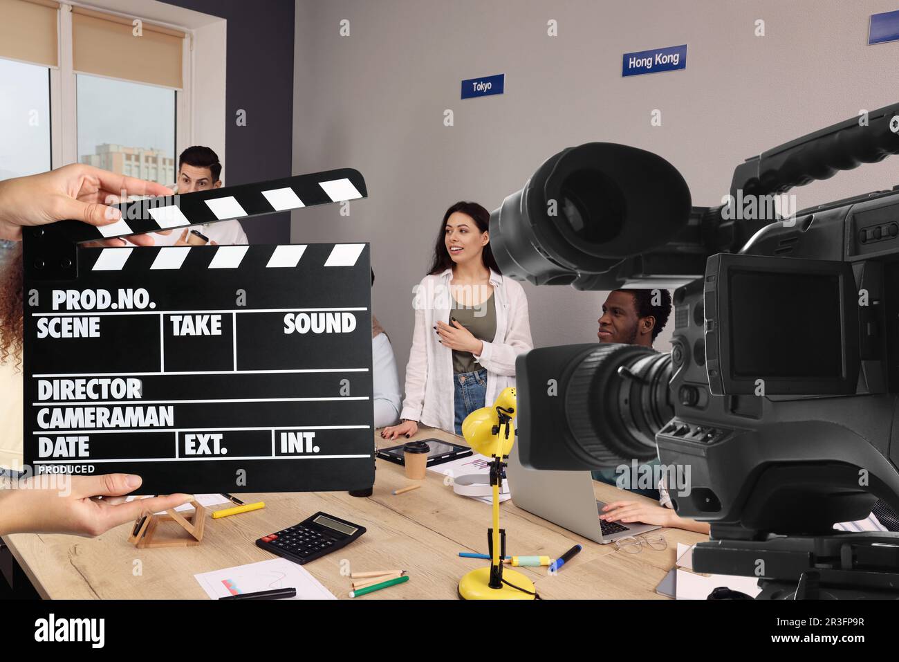 Shooting movie. Second assistant camera holding clapperboard near video ...