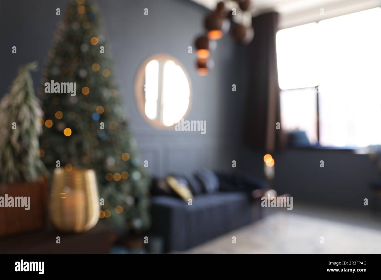 Blurred view of living room interior with Christmas tree and festive ...