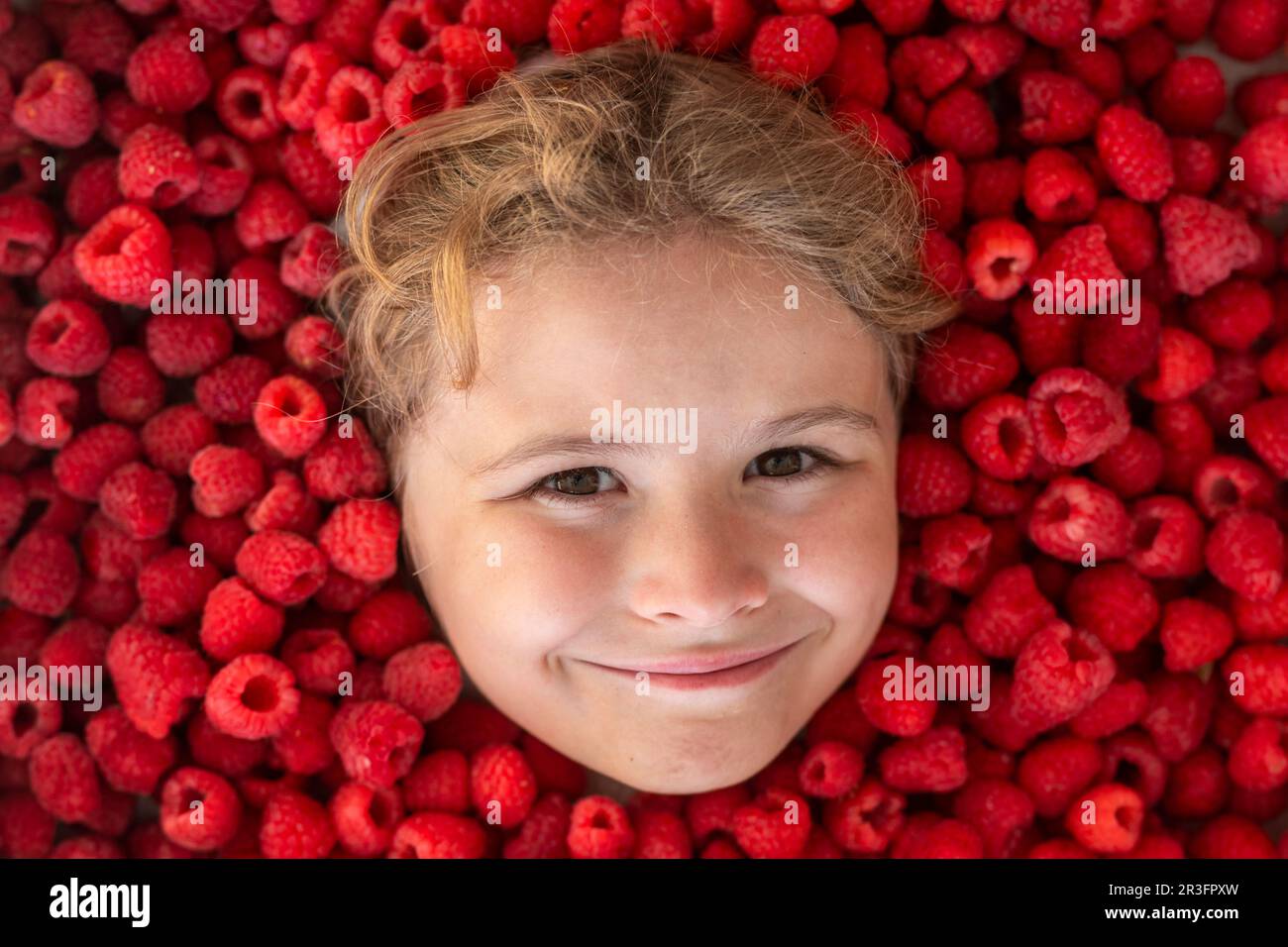 Child face with raspberry frame, close up raspberry background Stock ...